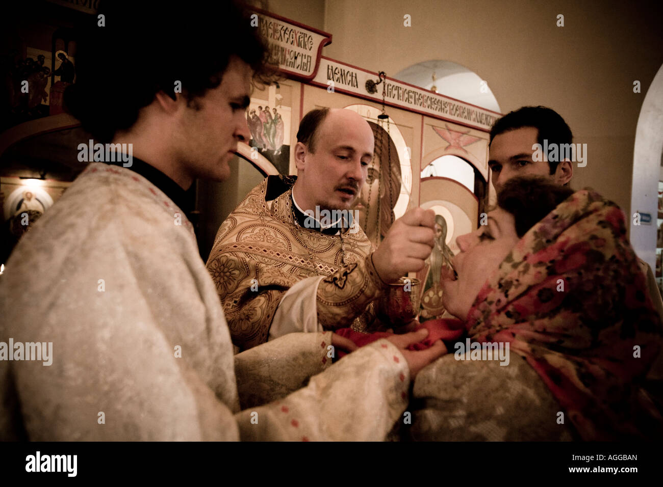 A woman receiving the holy communion in a russian orthodox church in ...