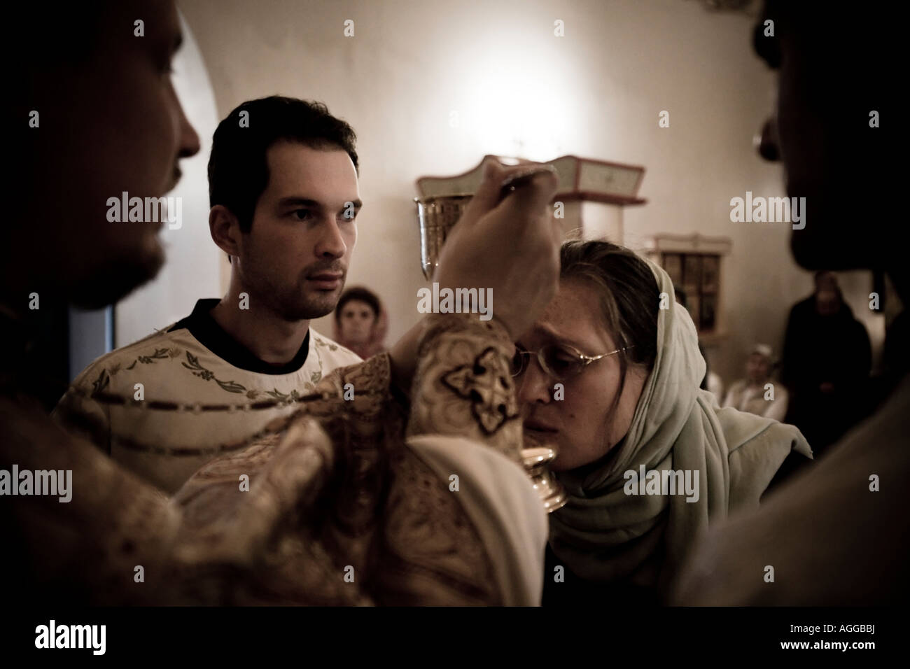 A woman receiving the holy communion in a russian orthodox church in ...