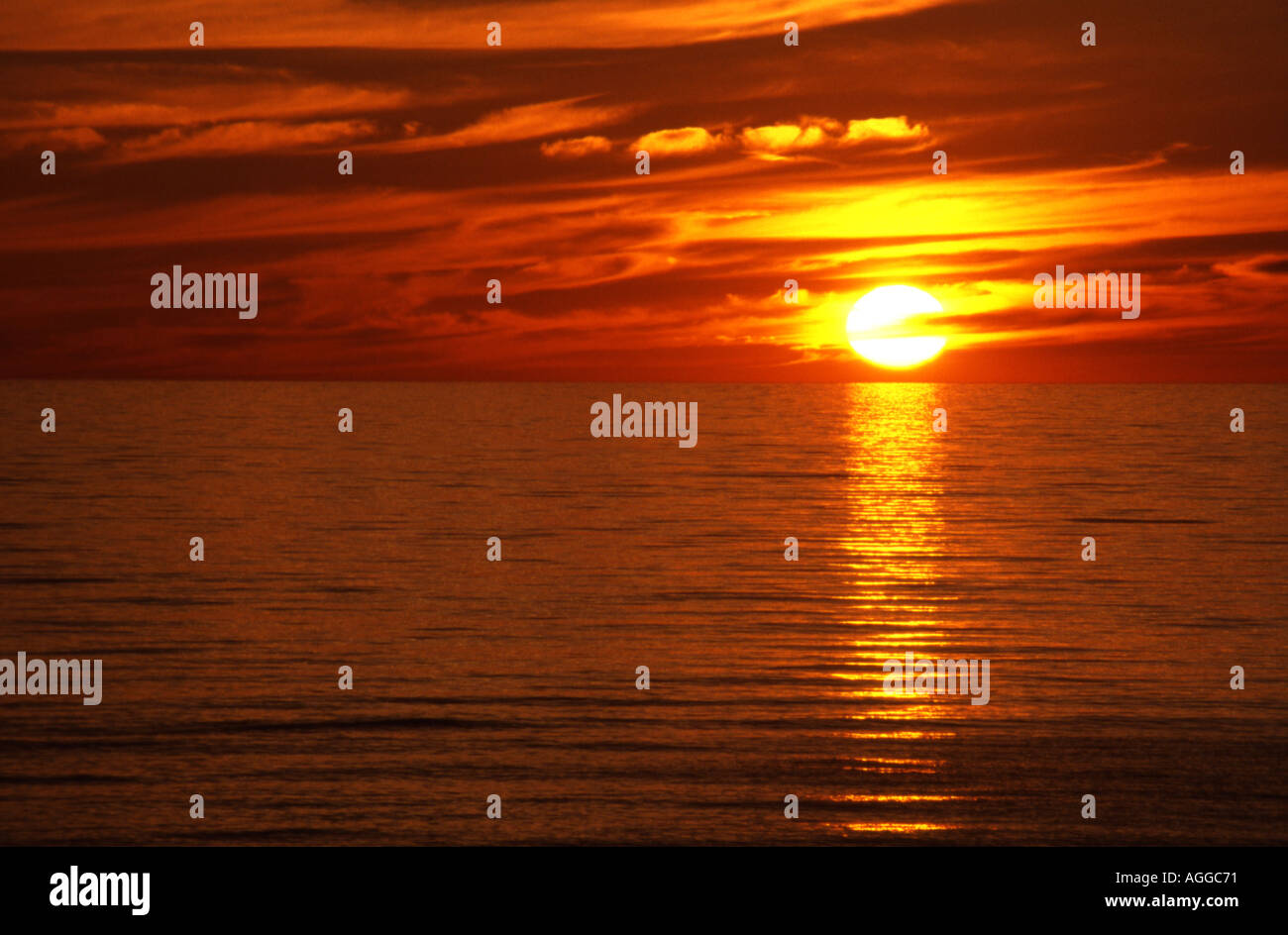 Sunset over water Stock Photo - Alamy