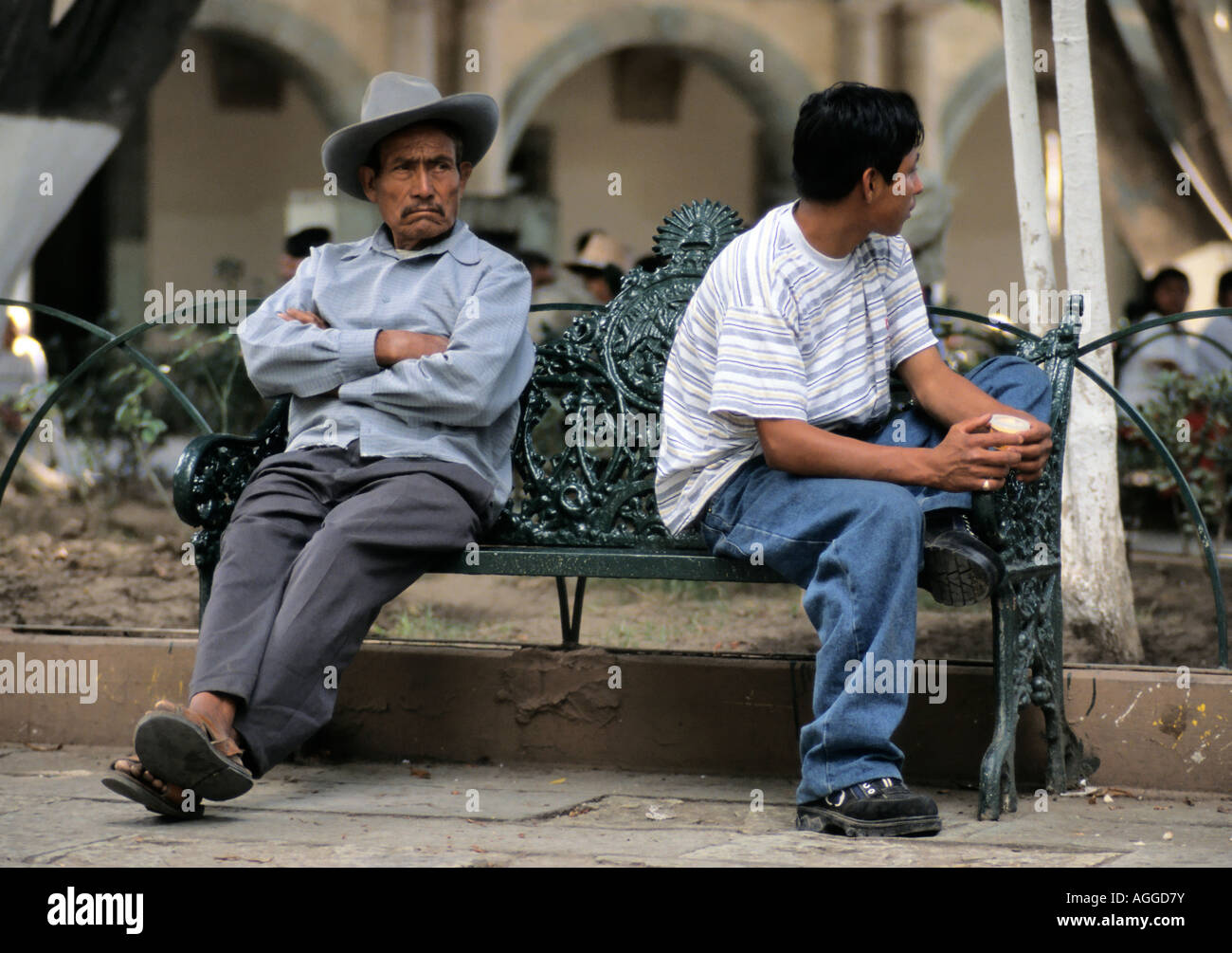 Men sitting at bench at Zocalo in Oaxaca, Mexico Stock Photo - Alamy