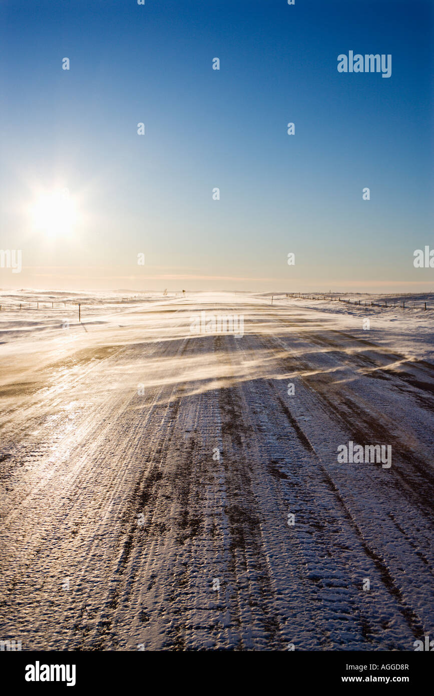 Ice covered road with tire tracks Stock Photo - Alamy
