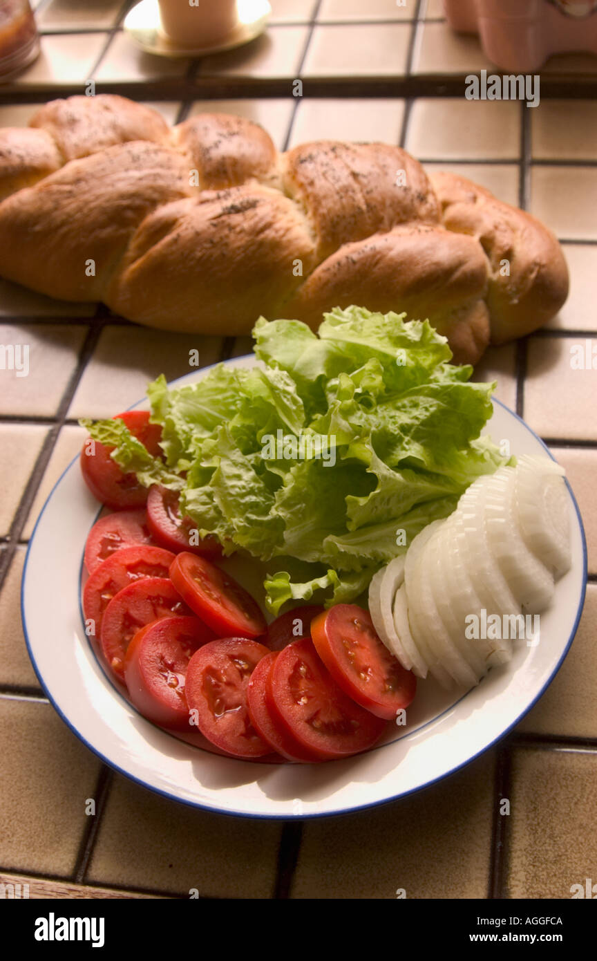 Bread Lettuce onions tomatoes for condiments at a barbeque Stock Photo ...