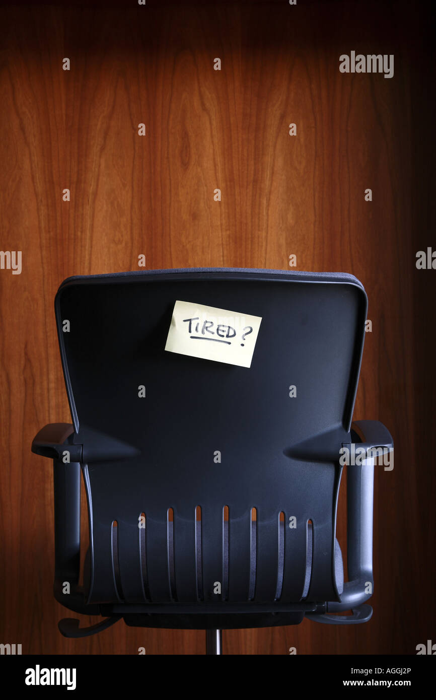 tired ? written on a post it note sticked on a armchair in an office ...