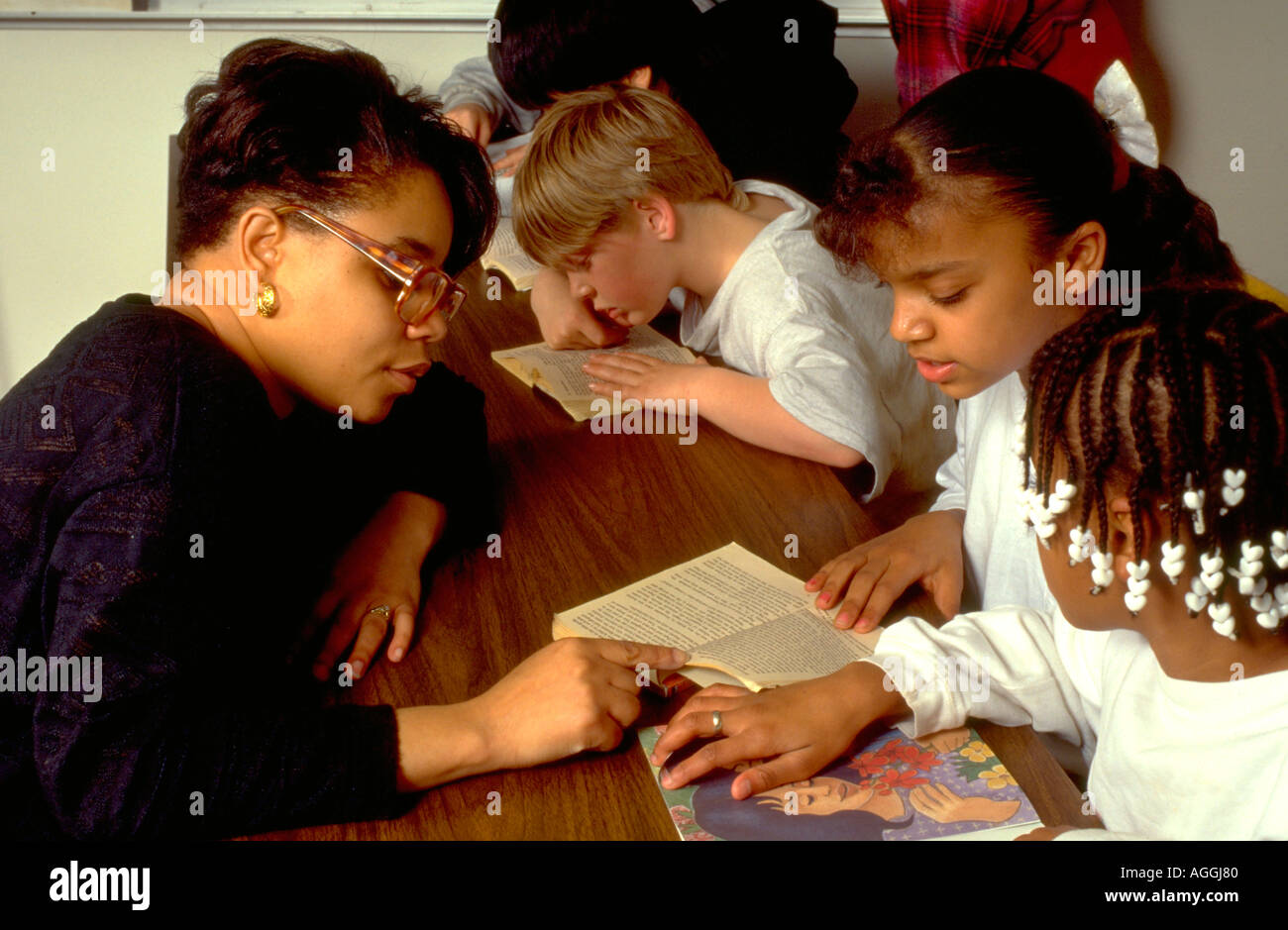 Inner city kids and teacher age 10 and 25 reading in after school ...