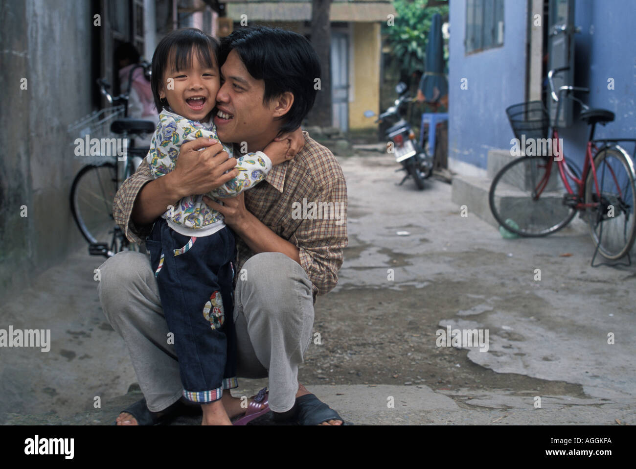 Asia Vietnam Hué Portrait of father and young daughter in front of home ...