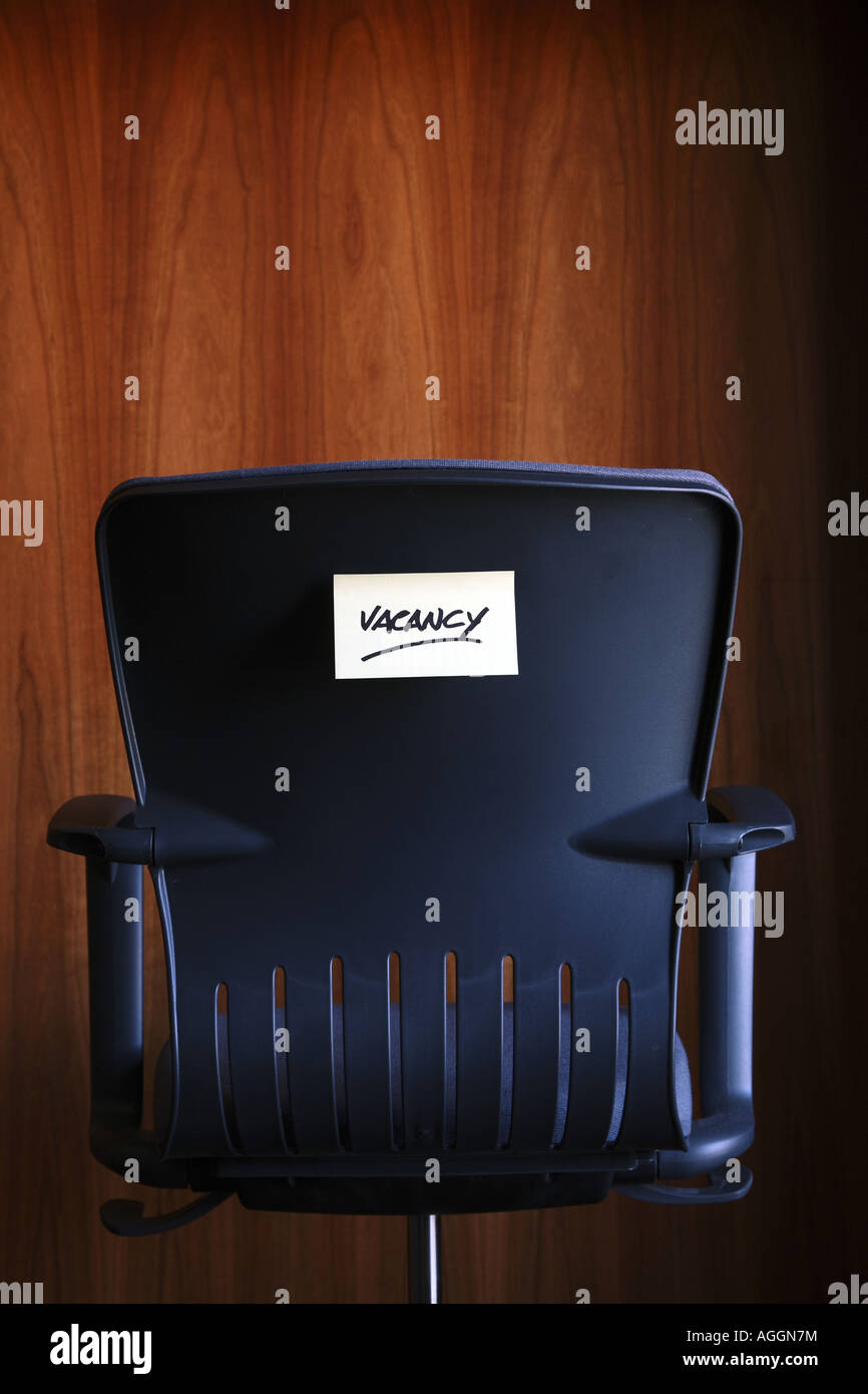 vacancy written on a post it note sticked on a armchair in an office ...