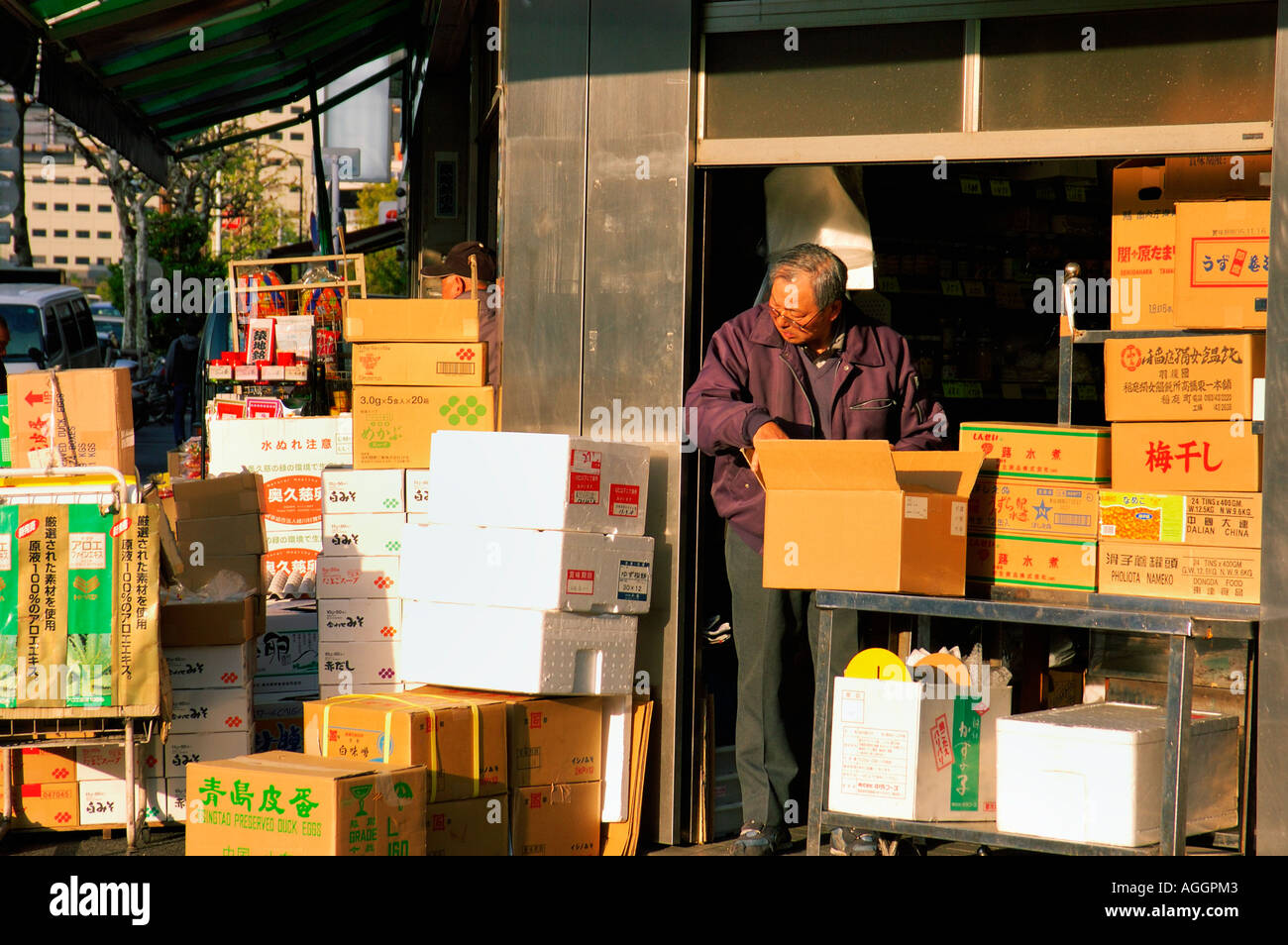 shop owner unpacking goods in early morning, Tokyo, Japan Stock Photo ...