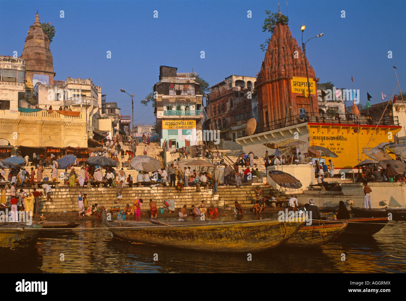 Crowds of pilgrims on Dasaswamedh and Prayag Ghats, with row boats ...