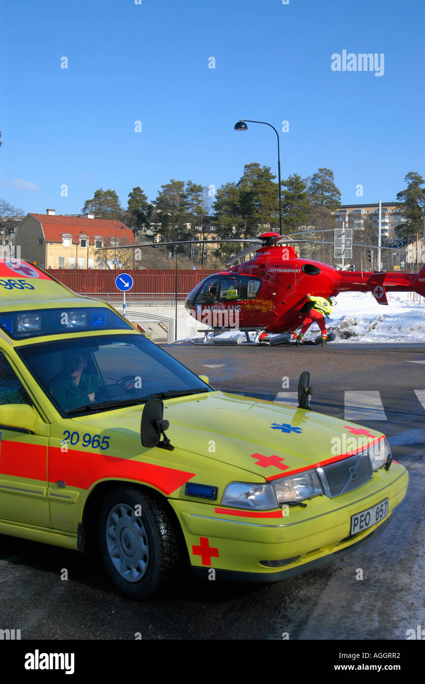 emergency helicopter / ambulance and rescue personnel and victim at ...