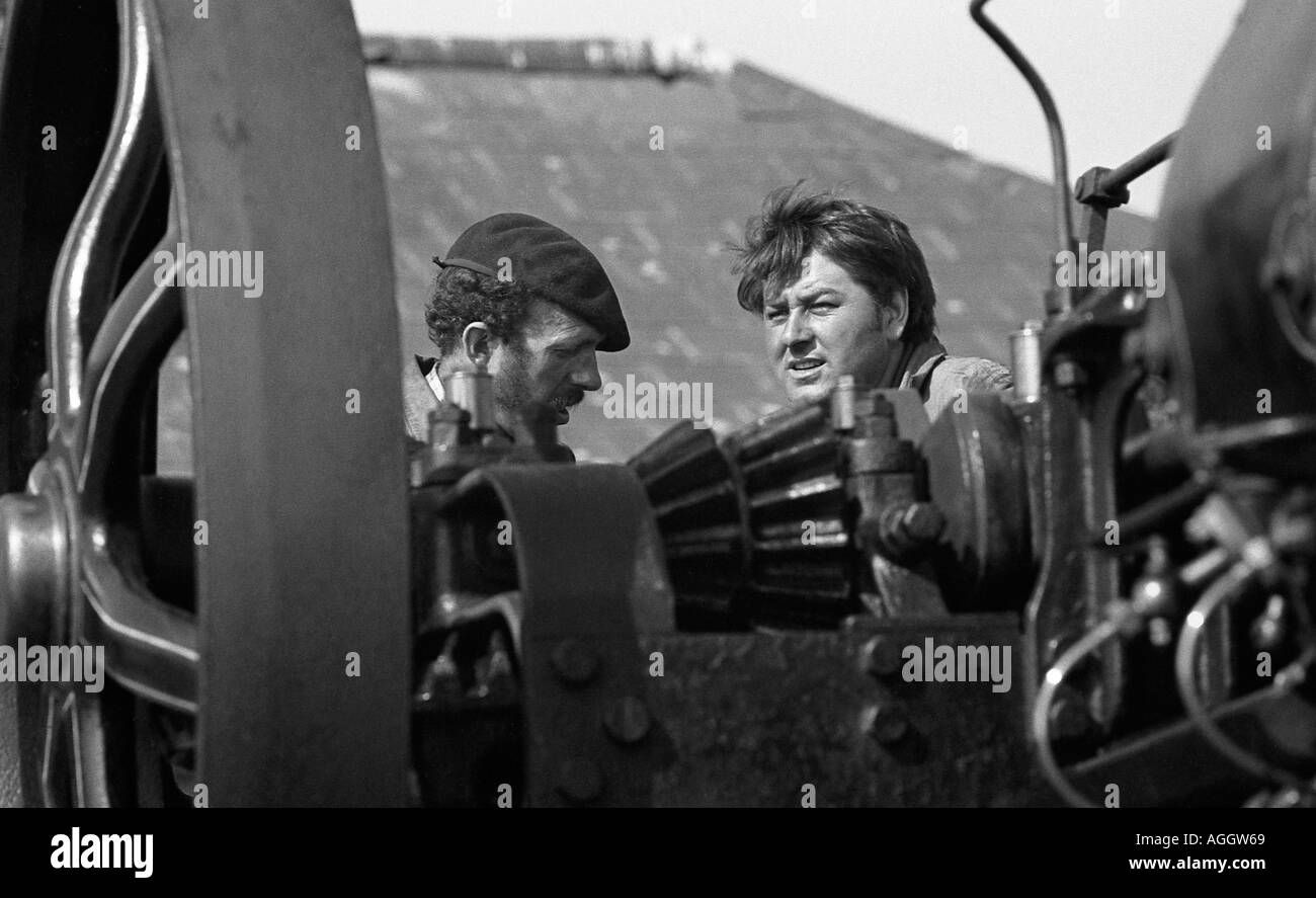 Two men discussing the engineering of a steam traction engine Stock ...