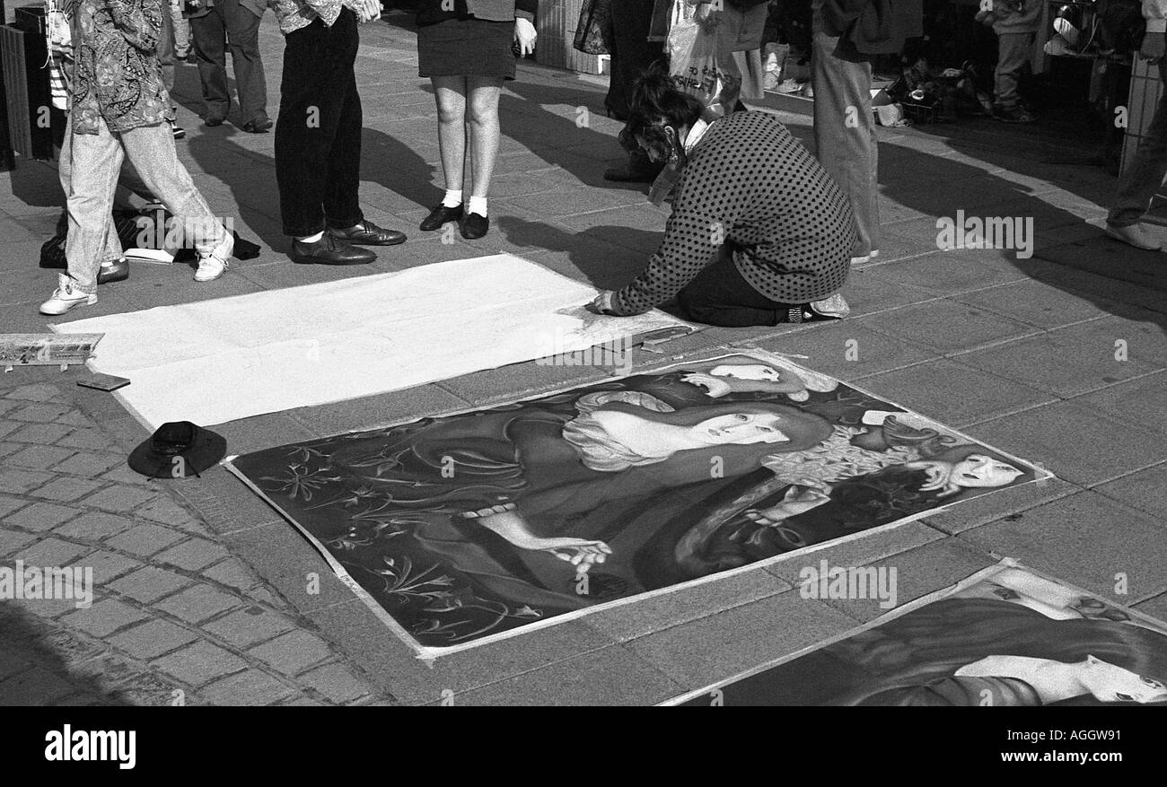 Pavement artist working in town center begging from public Stock Photo ...