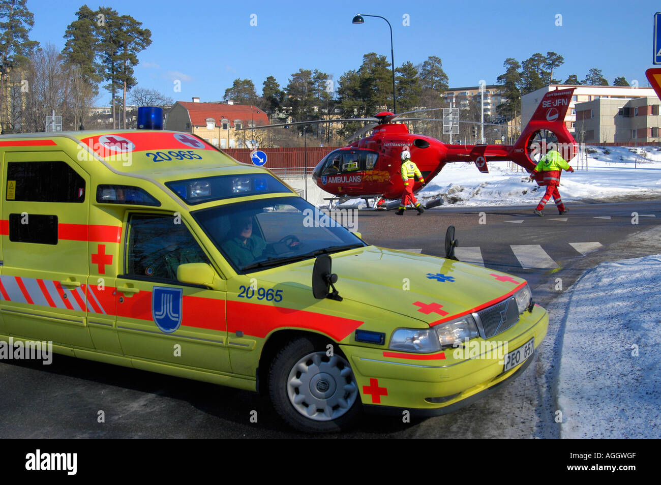emergency helicopter / ambulance and rescue personnel and victim at ...