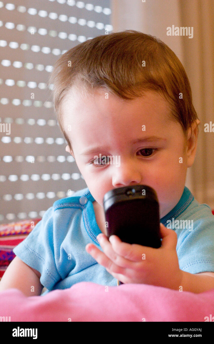 boy and mother on couch playing with the remote control Stock Photo - Alamy