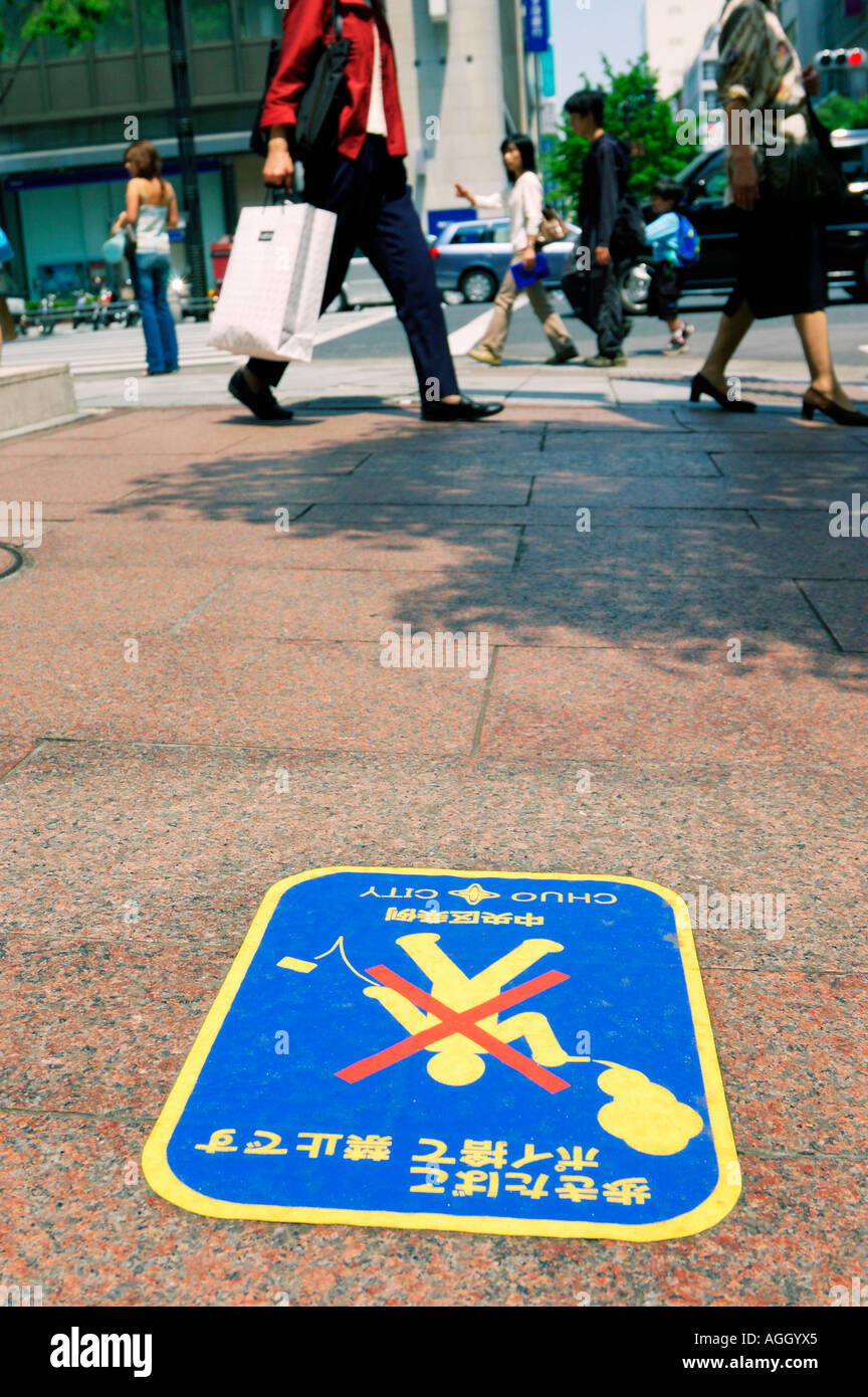 warning sign on sidewalk, Tokyo, Japan Stock Photo - Alamy