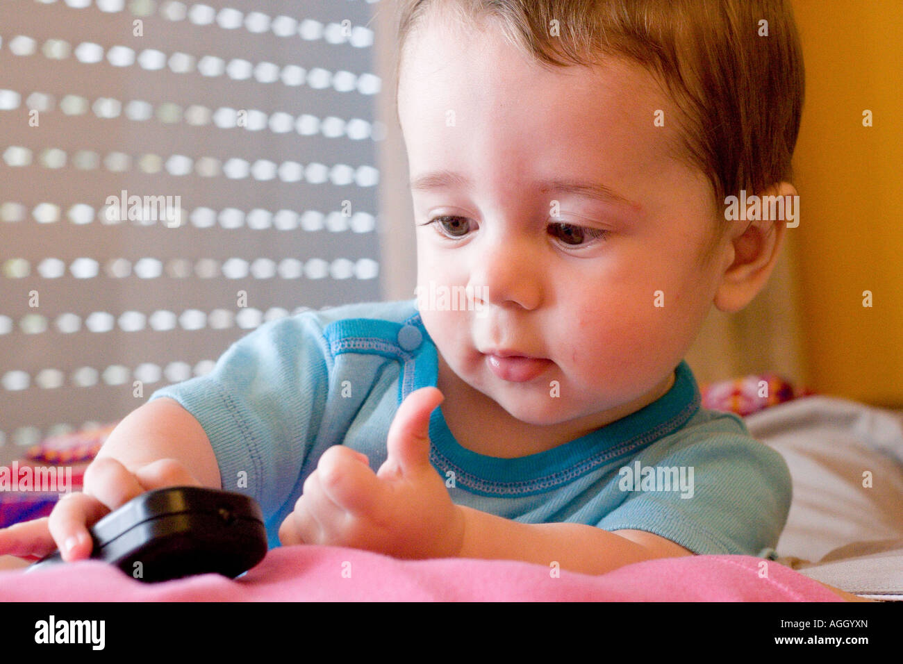 boy and mother on couch playing with the remote control Stock Photo - Alamy