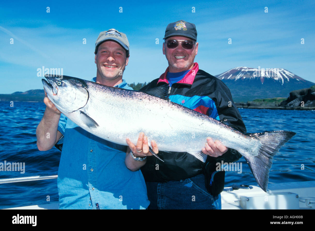 Salmon fishing charter boat skipper and a client with a Chinook salmon ...