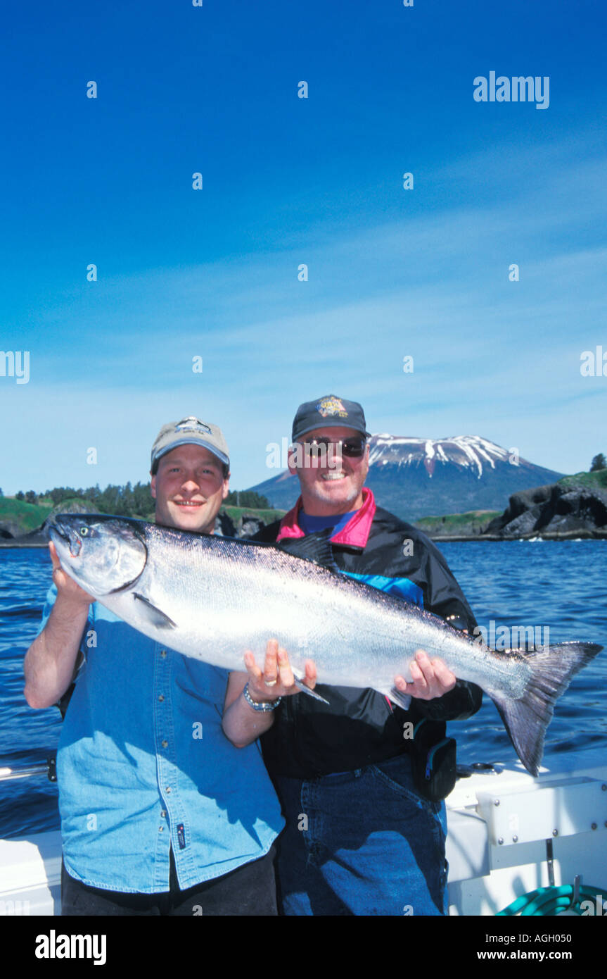 Salmon fishing charter boat skipper and a client with a Chinook salmon ...