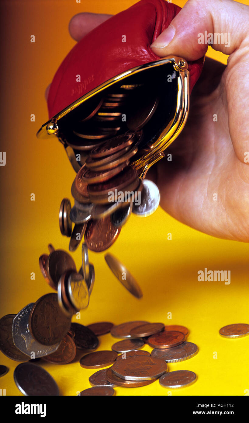 money falling out of bulging ladys purse uk sterling Stock Photo - Alamy