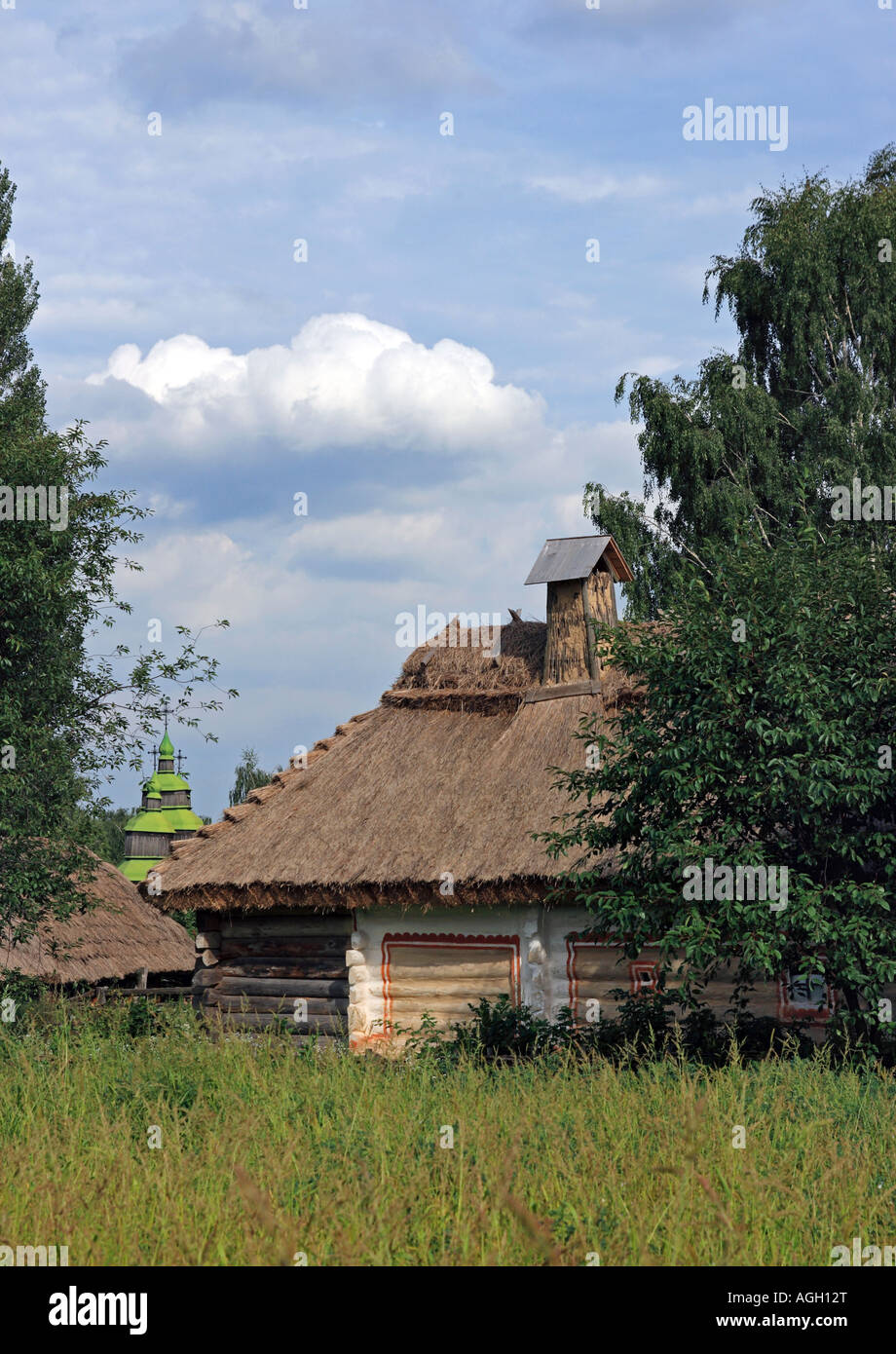 Ukrainian old historical farmhouse and church behind Stock Photo - Alamy