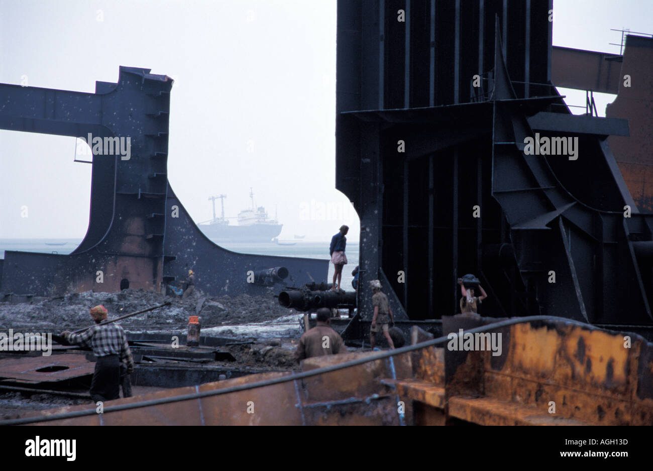 Bangladesh ship breaking yard (Chittagong). Ship recycling yard with industrial workers, heavy ...