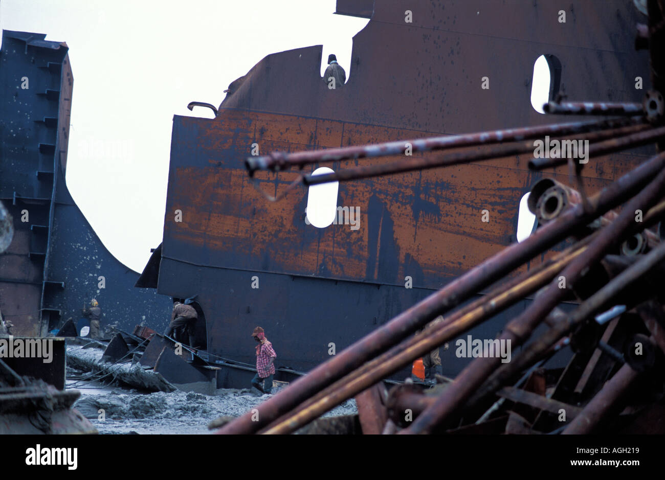 Bangladesh ship breaking yard (Chittagong). Ship recycling yard with industrial workers, heavy ...