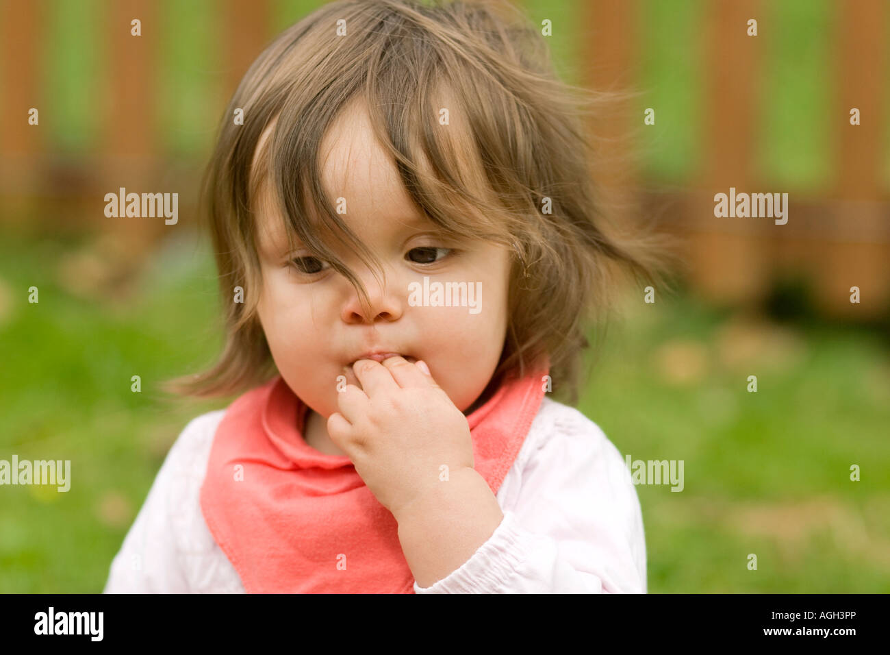 baby girl eating her fingers Stock Photo - Alamy