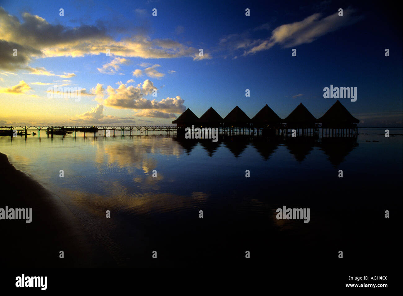 Sunset over ocean bungalows in Moorea Stock Photo - Alamy