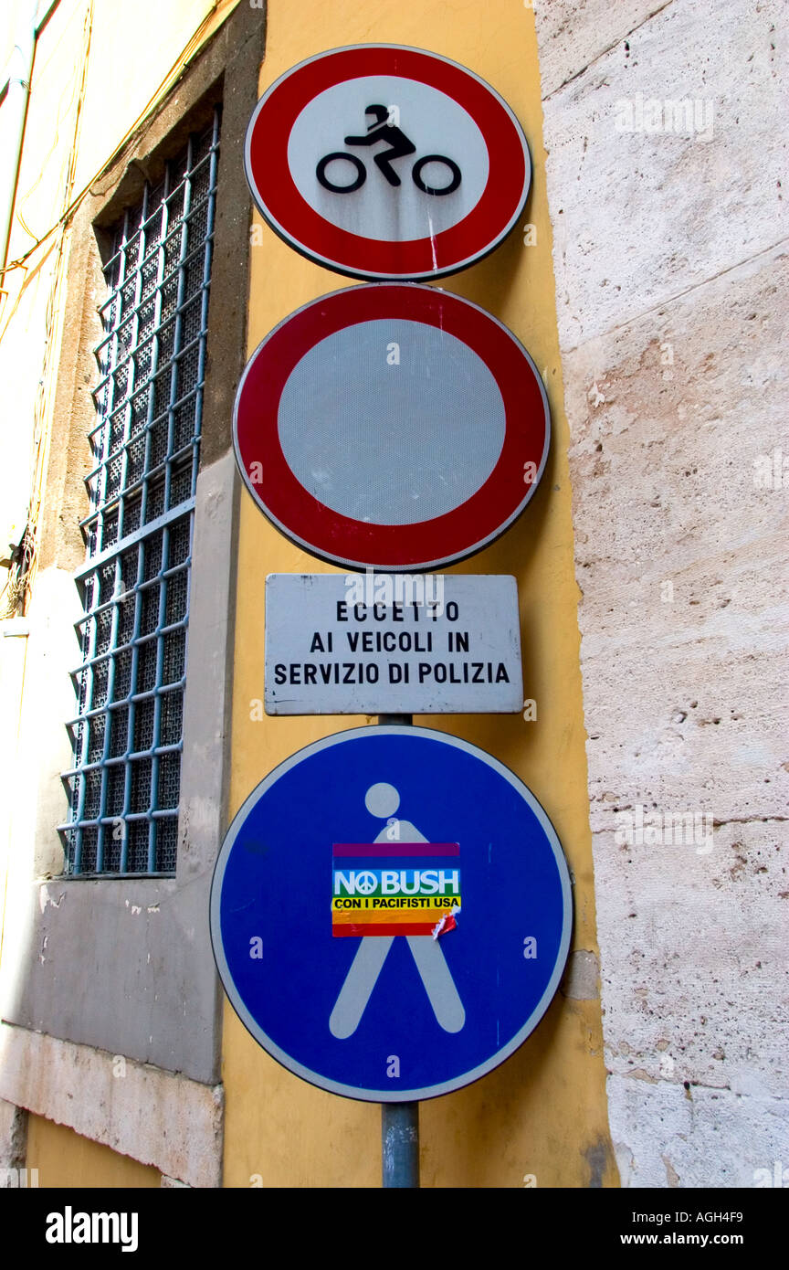 Street signs in Rome with political banner Stock Photo - Alamy