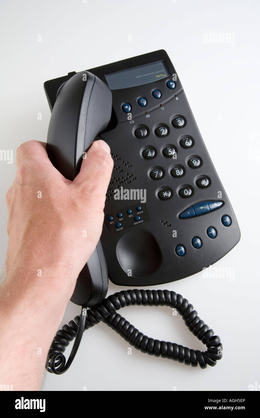 A hand answering a telephone Stock Photo - Alamy