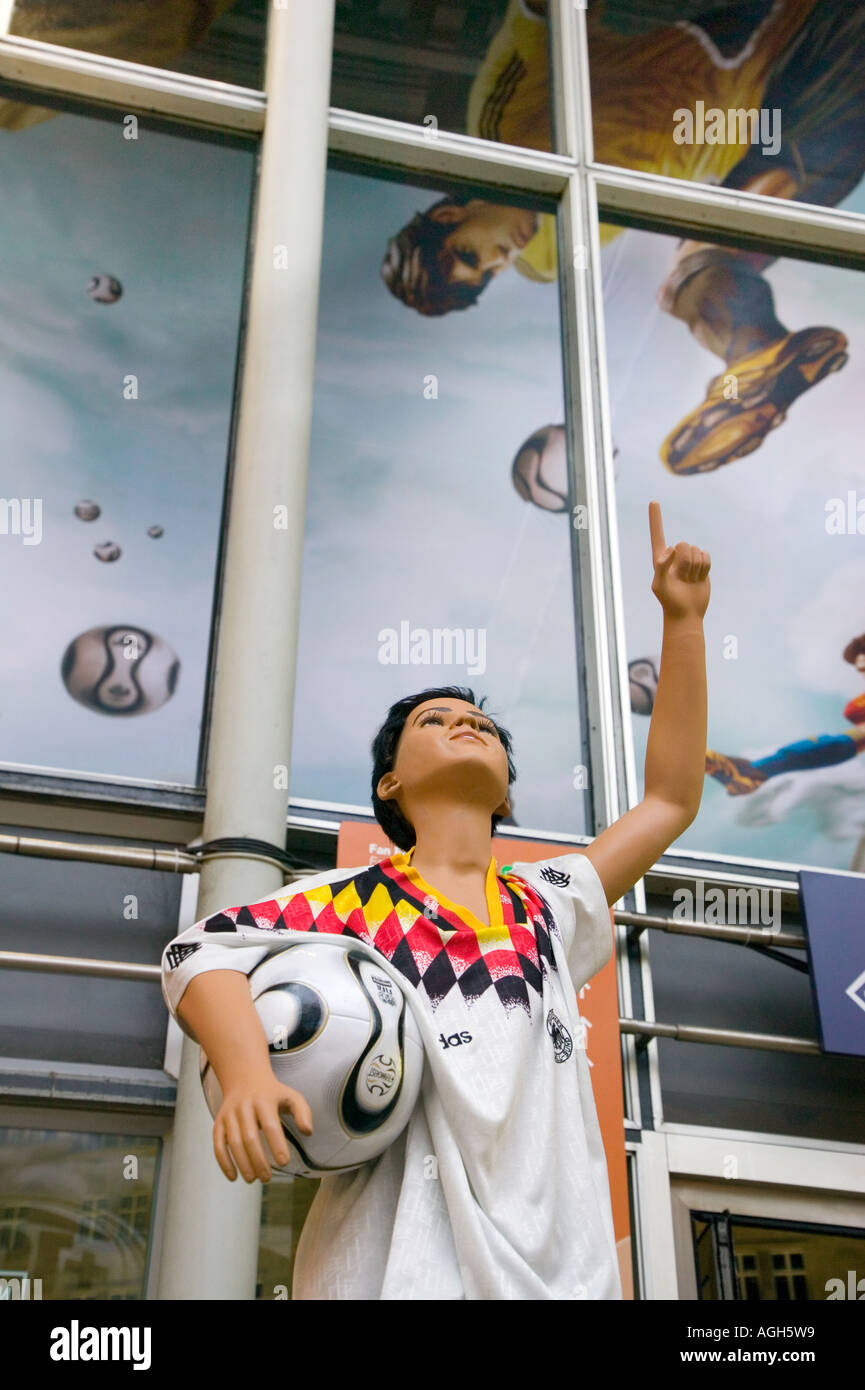 Boy with Germany soccer uniform points up to painted players on roof at ...