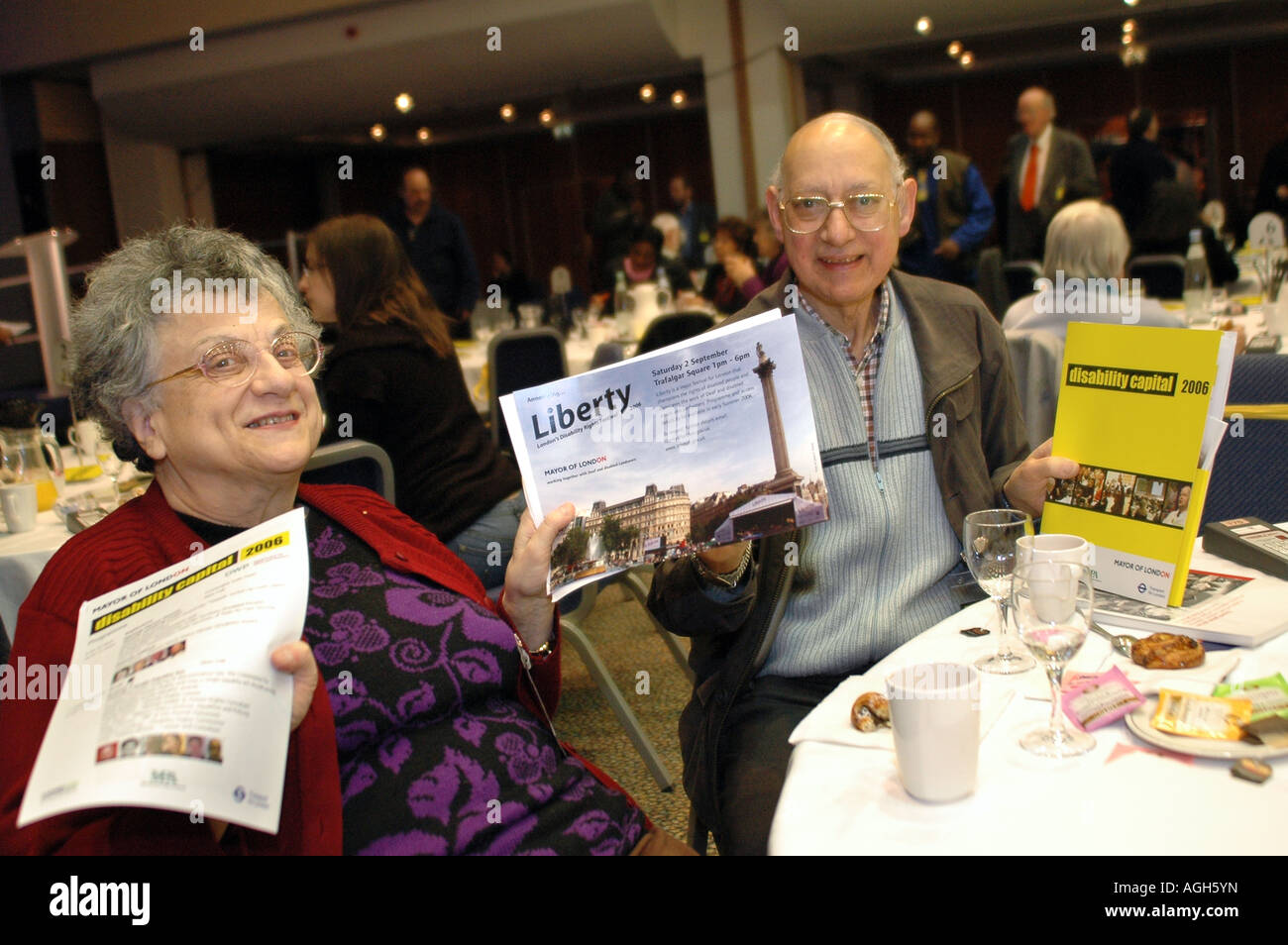 Disabled elderly couple showing leaflets about disability at the ...