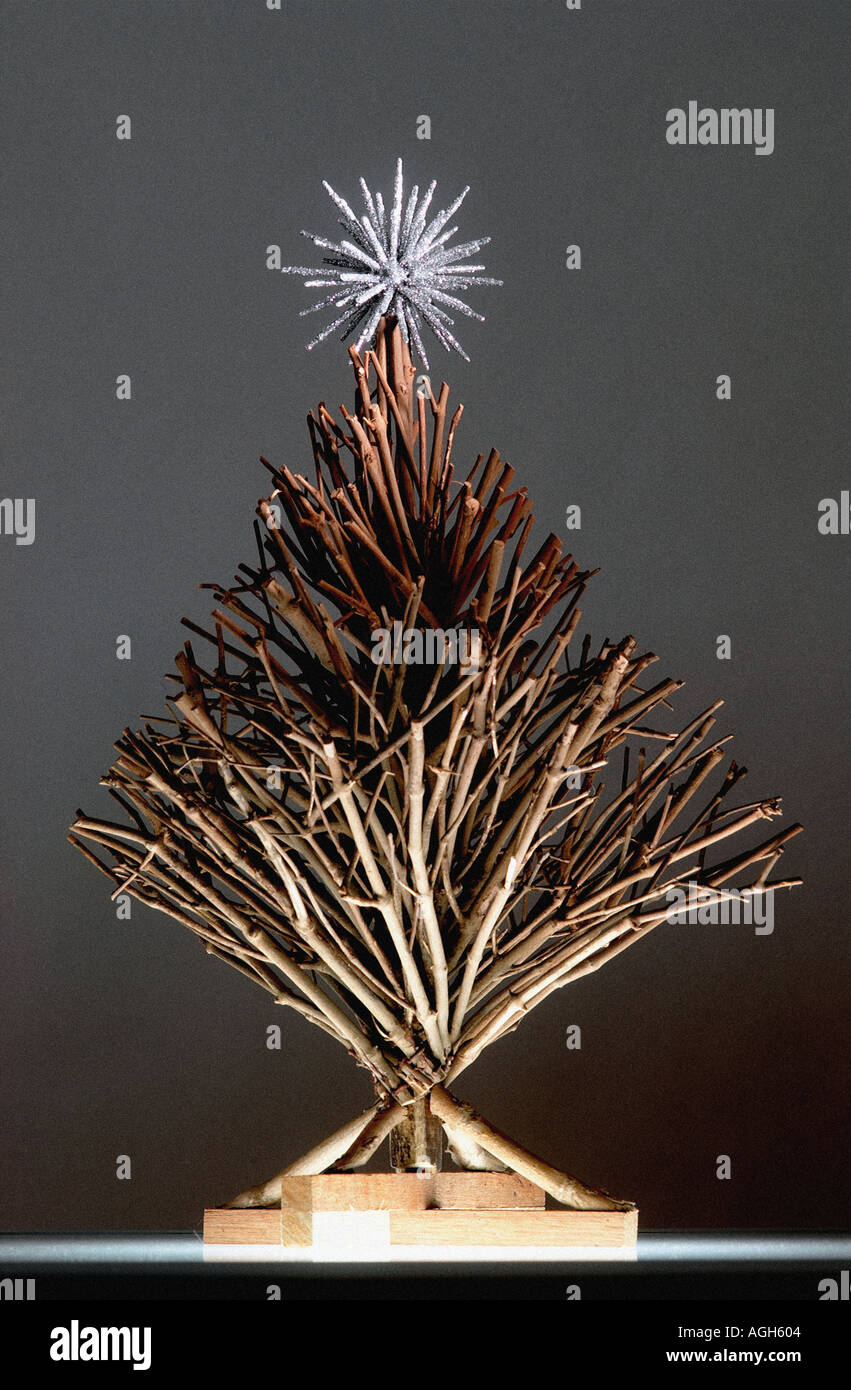 Wooden Christmas tree made of twigs with silver spiky decoration on top ...