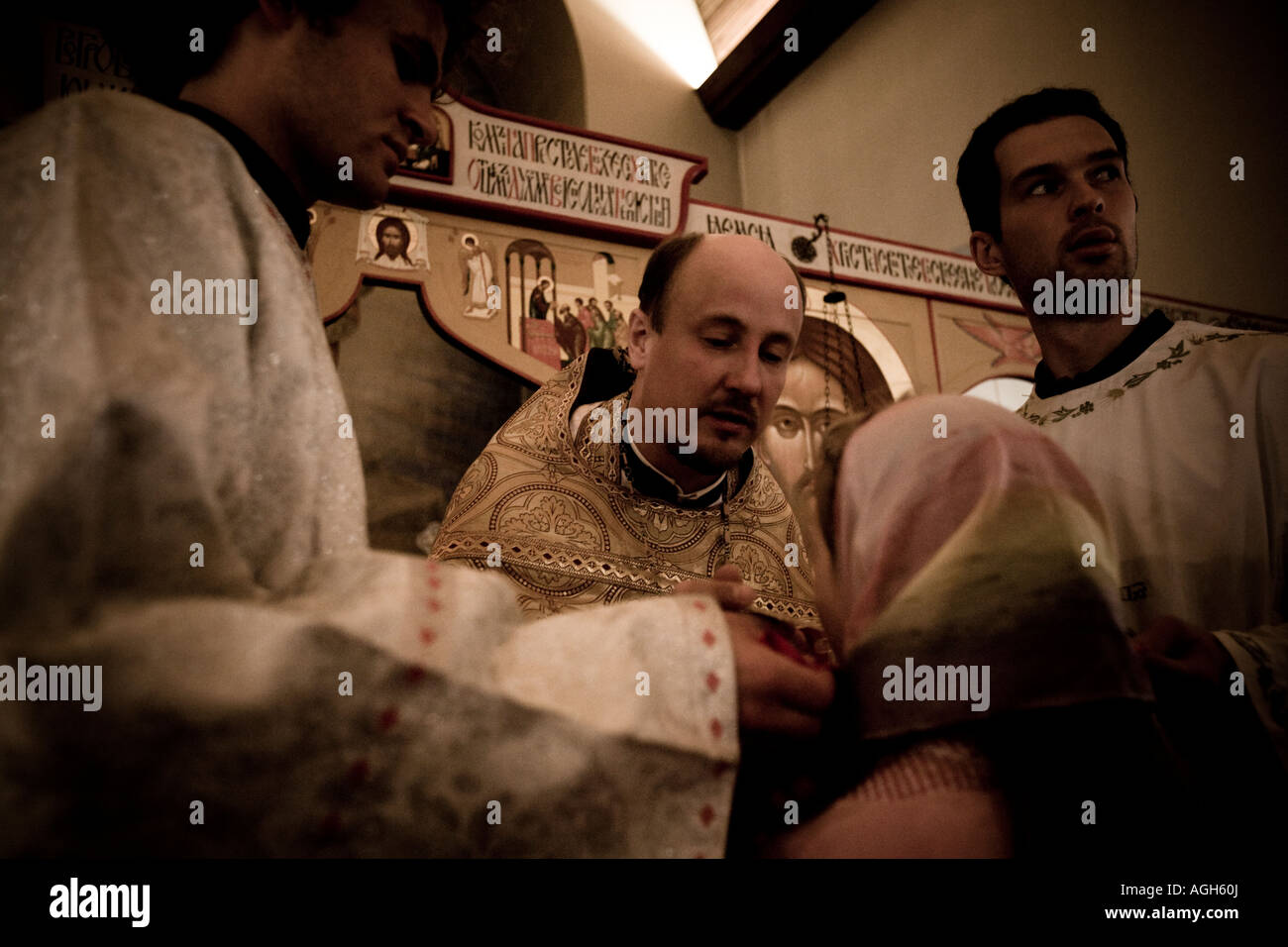 A little girl receiving the holy communion in a russian orthodox church ...