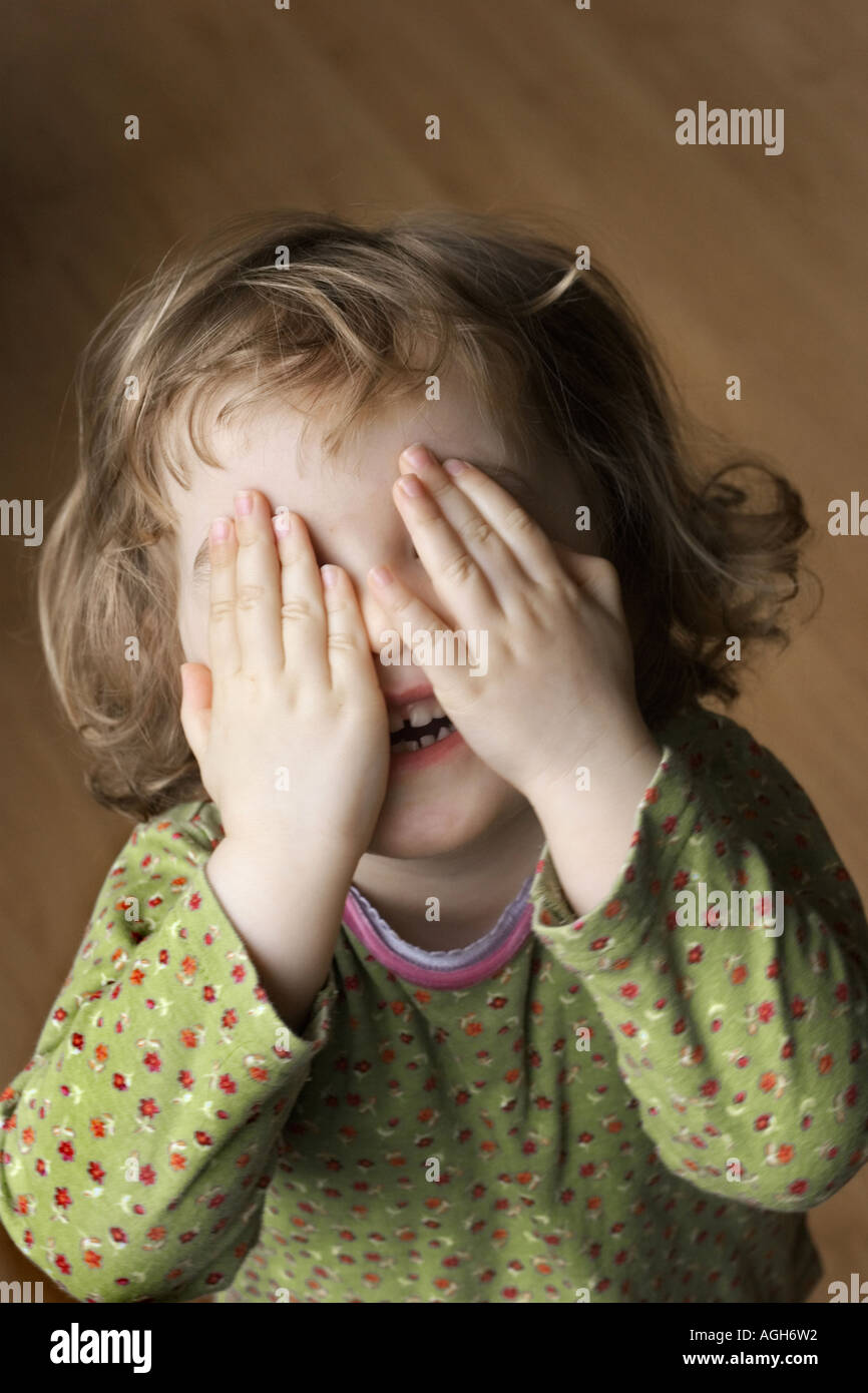 Girl hiding behind chair hi-res stock photography and images - Alamy