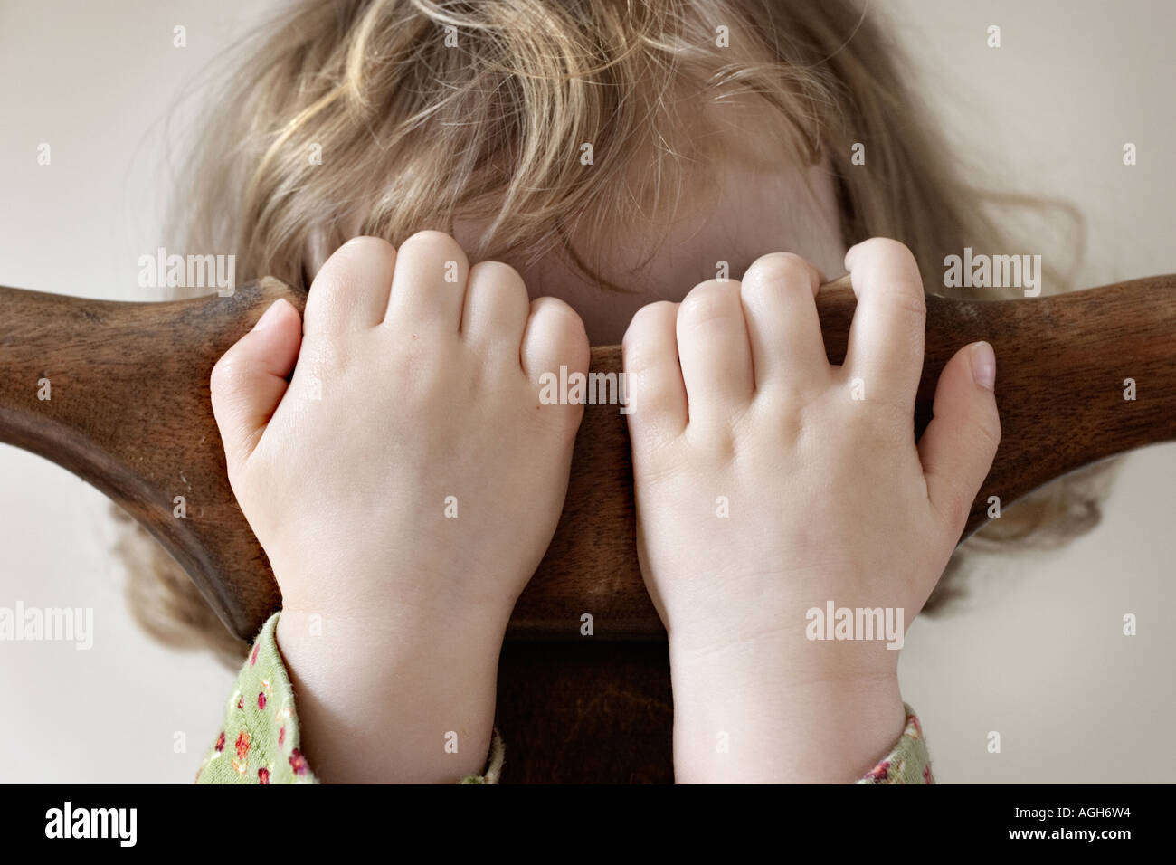young child hiding behind hands Stock Photo - Alamy