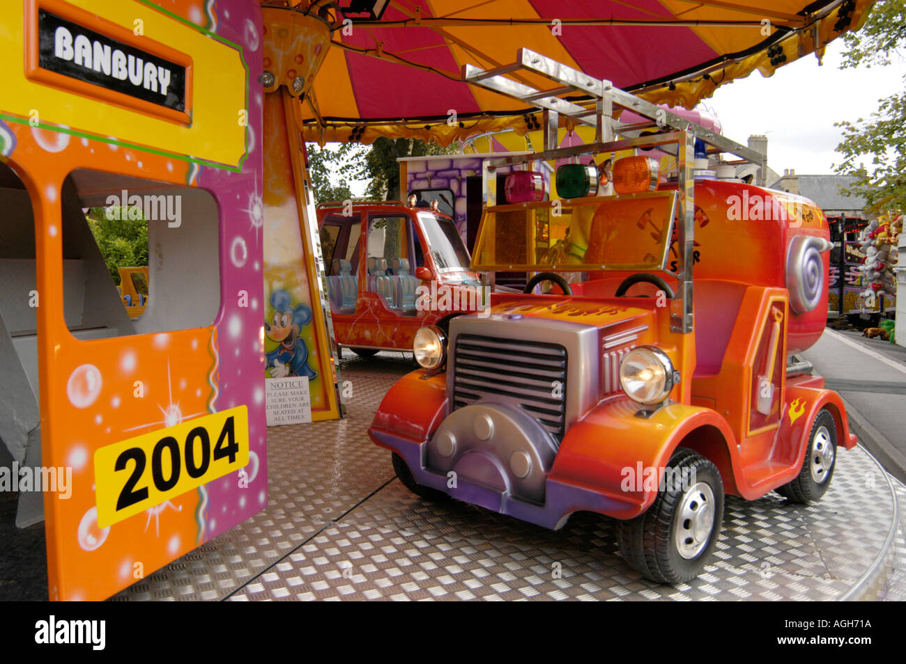 Banbury bus and fire engine on childrens roundabout at the fair Stock ...