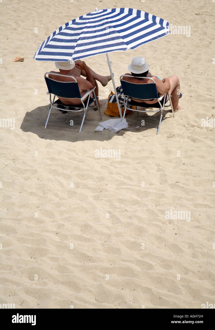 People relaxing at a beach in Cala Bassa, Ibiza, Spain Stock Photo - Alamy