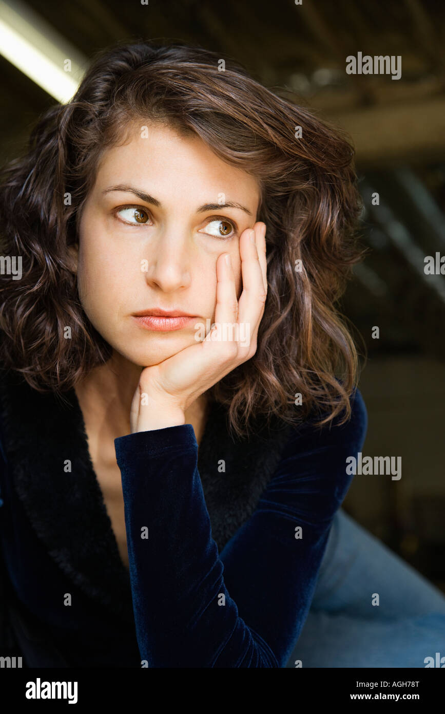 Portrait of pretty mid adult Caucasian woman with head on hand looking ...