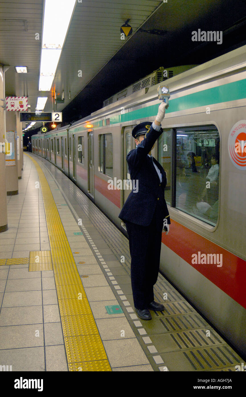 train attendant/stationmaster with signal lamp, Tokyo, Japan Stock ...
