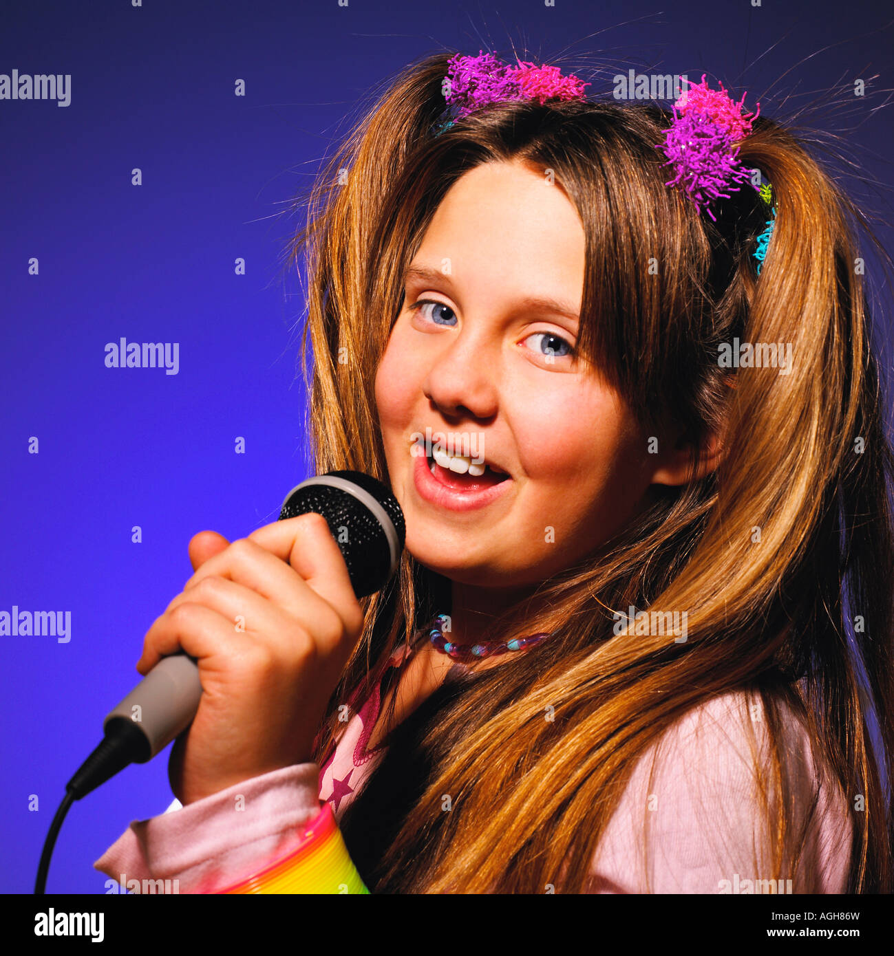 Young teen singing into microphone Stock Photo - Alamy
