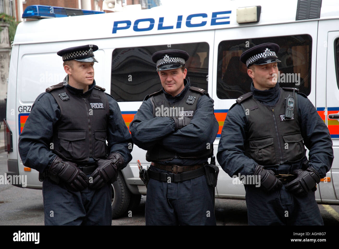 Group of police in protective clothing with van Stock Photo - Alamy
