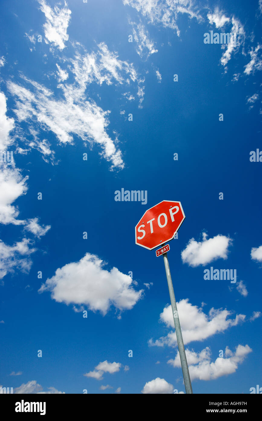 Stop sign with blue cloudy sky Stock Photo - Alamy