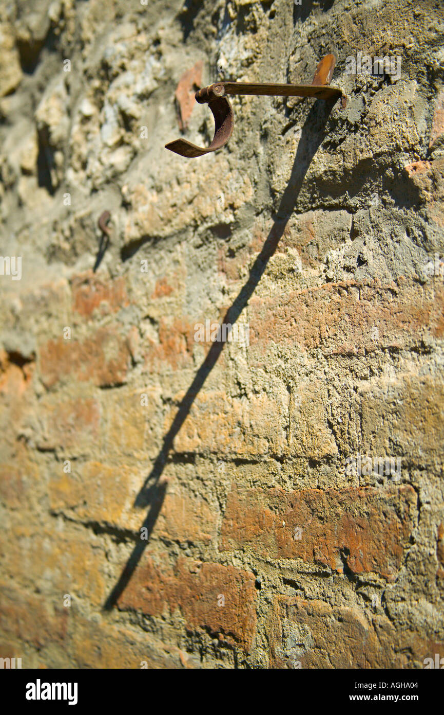 Shutter hook and shadow on wall, San Gimignano, Tuscany, Italy Stock ...