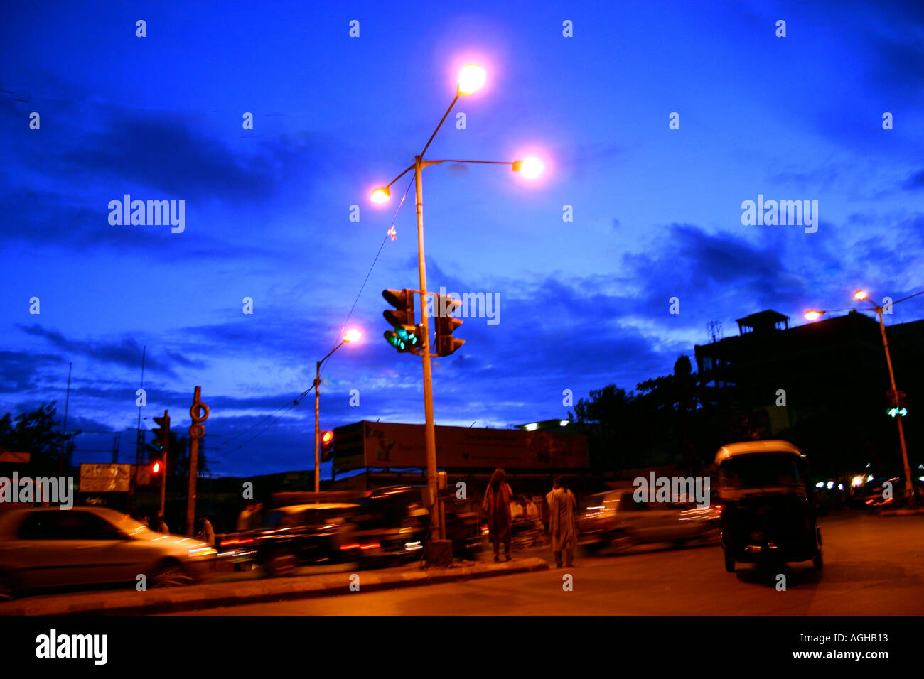 Dramatic blue twilight sky with the street lights the regular traffic ...