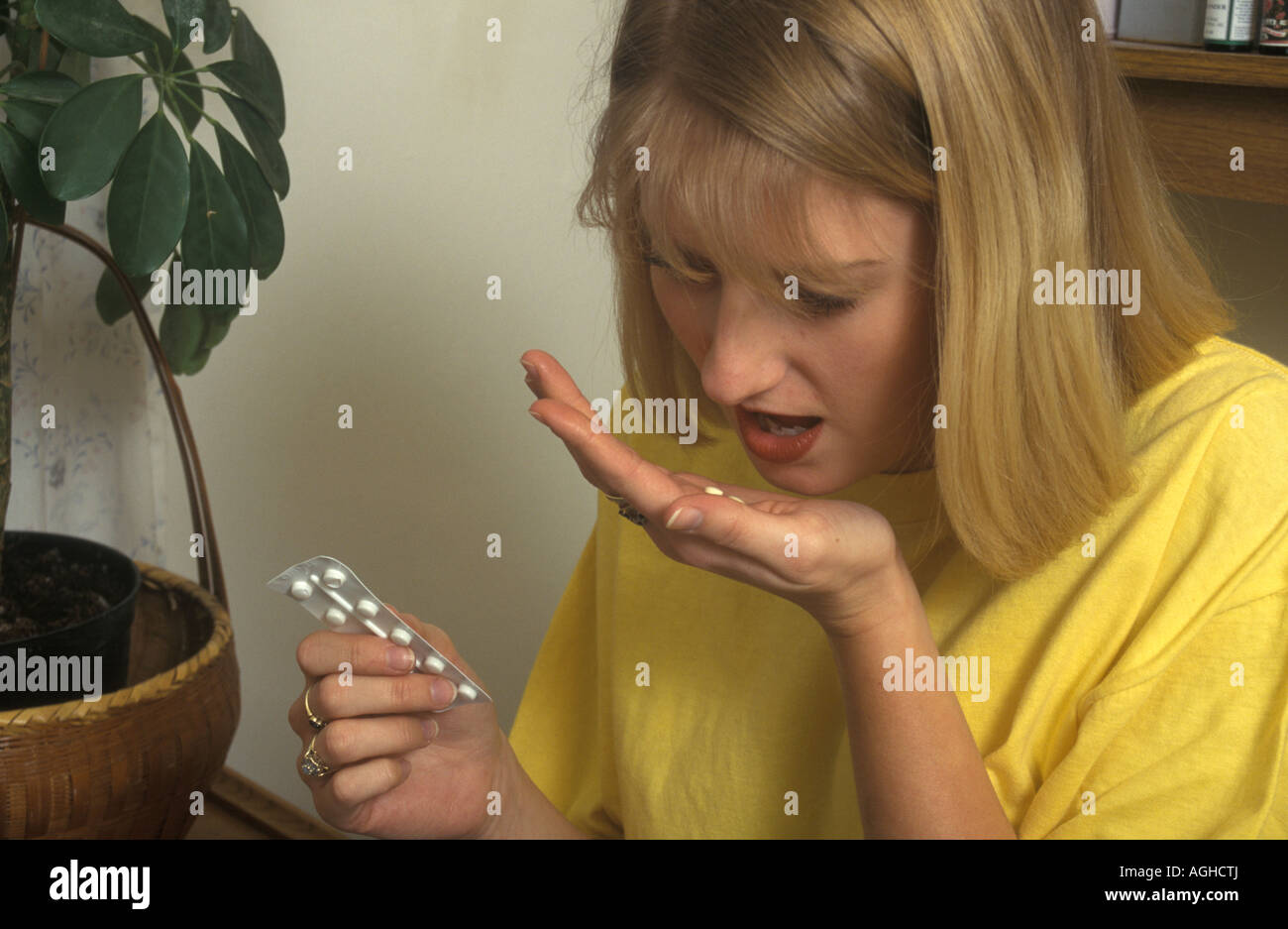 teenage girl taking pills Stock Photo - Alamy