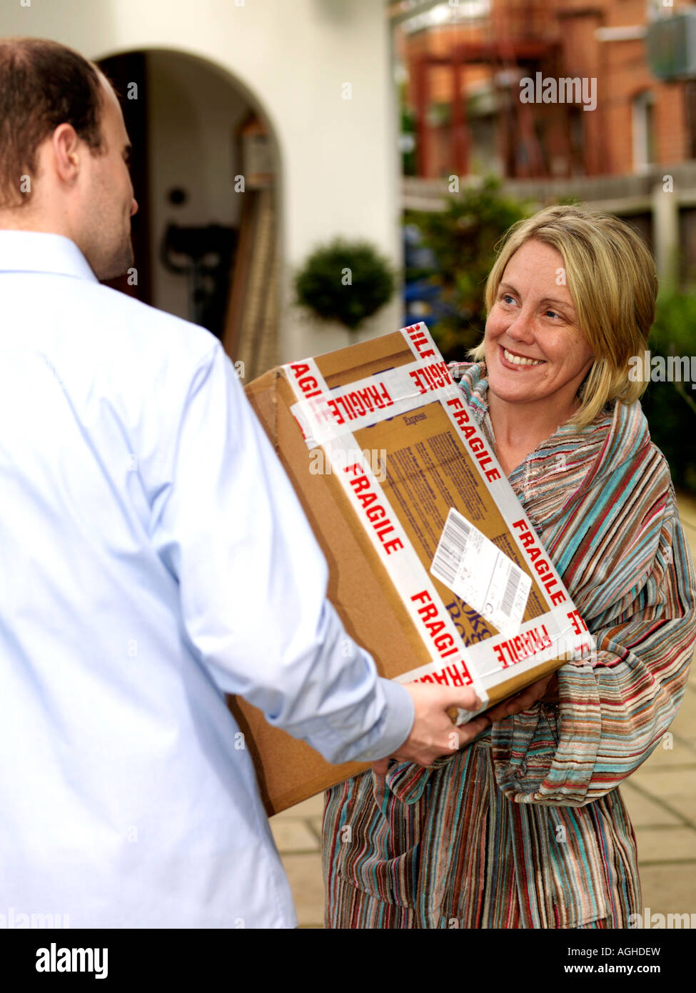 Postman delivers package hi-res stock photography and images - Alamy
