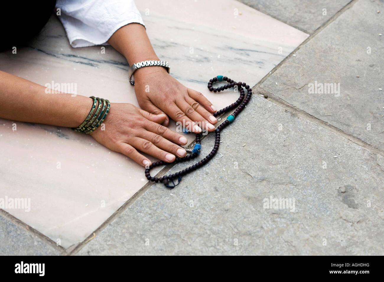 Nepalise woman prostrating with prayer beads. Swayambhu Stupa ...