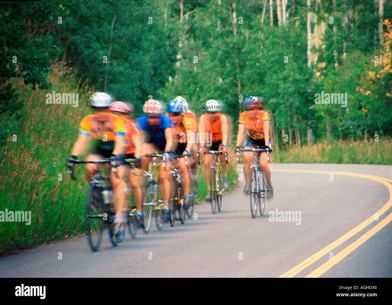 A group of cyclists riding down a highway Stock Photo - Alamy
