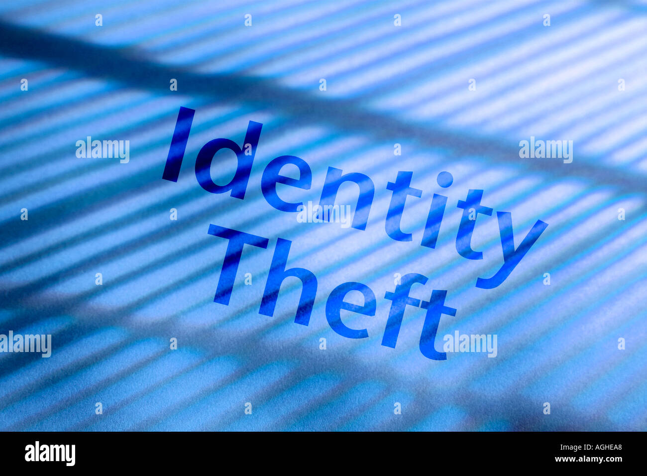 Identity theft on a blue background Stock Photo - Alamy