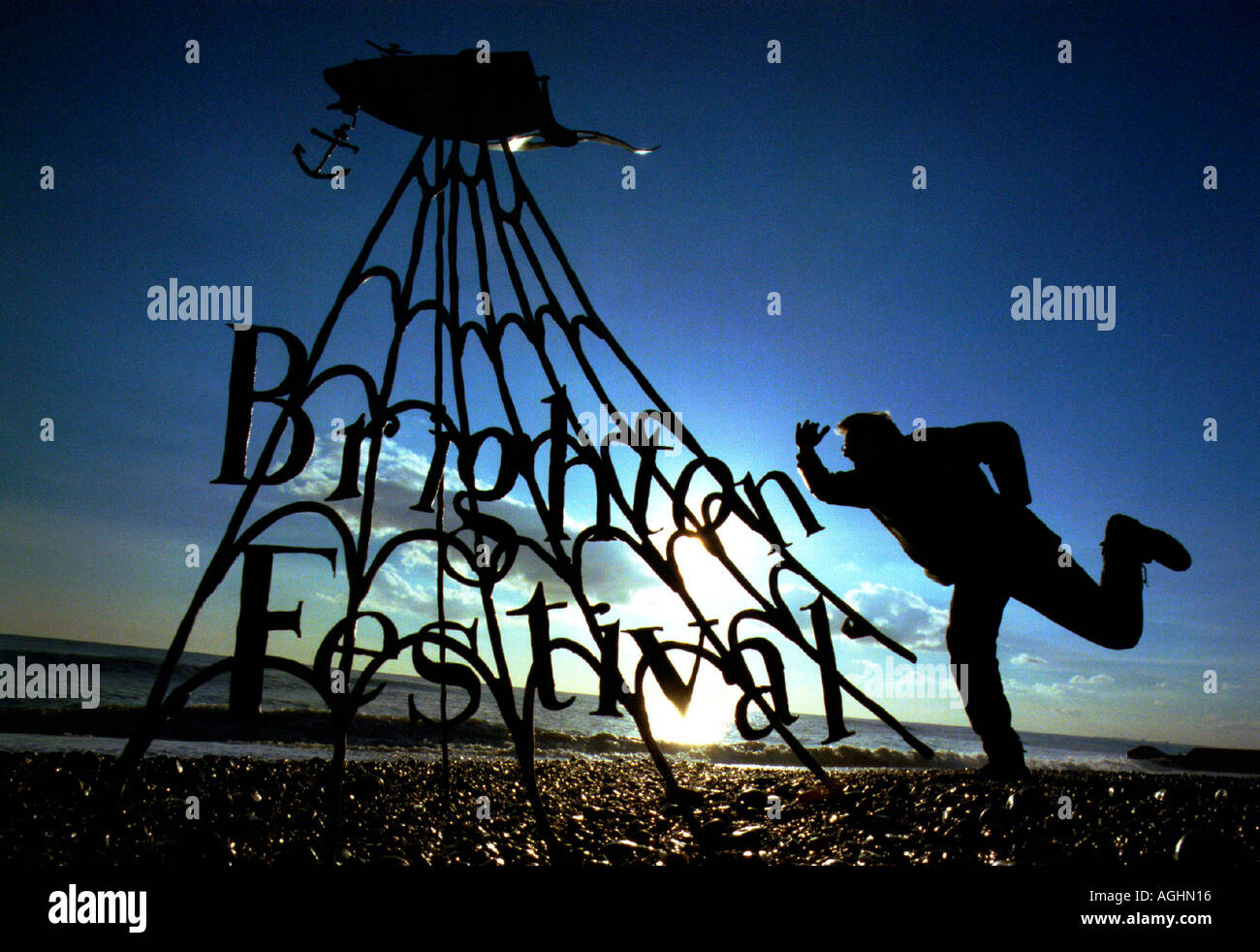 Proud artist leaps about in front of his sculpture inspired by the ...